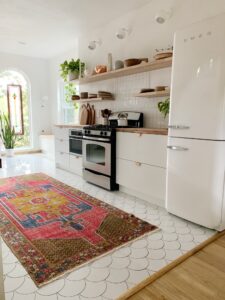 A Clever Cutout and White Kitchen Cabinets Make This Renovation Cozy