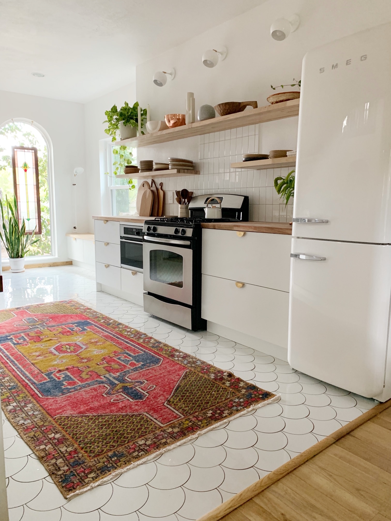 A Clever Cutout and White Kitchen Cabinets Make This Renovation Cozy