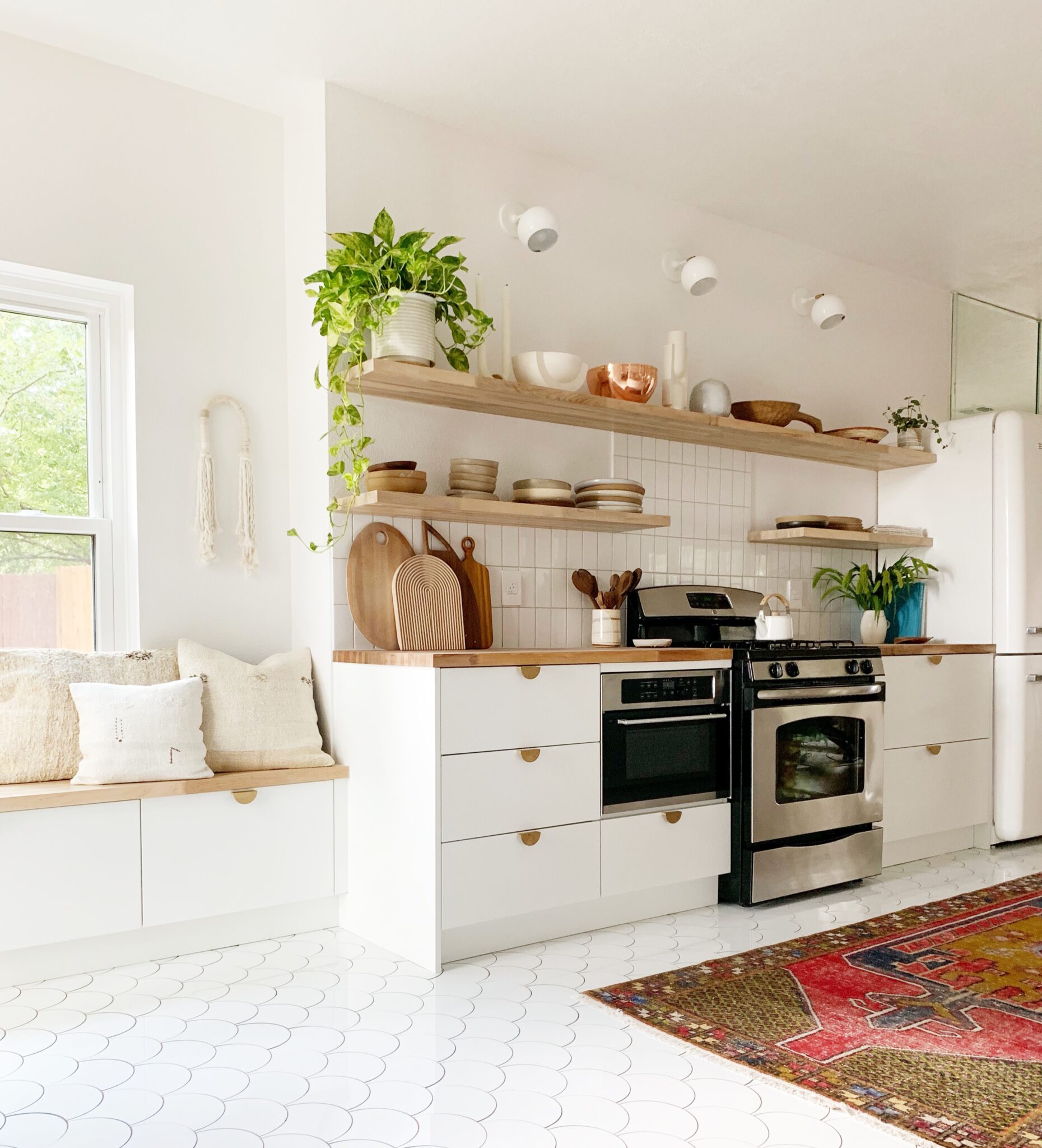 A Clever Cutout and White Kitchen Cabinets Make This Renovation Cozy