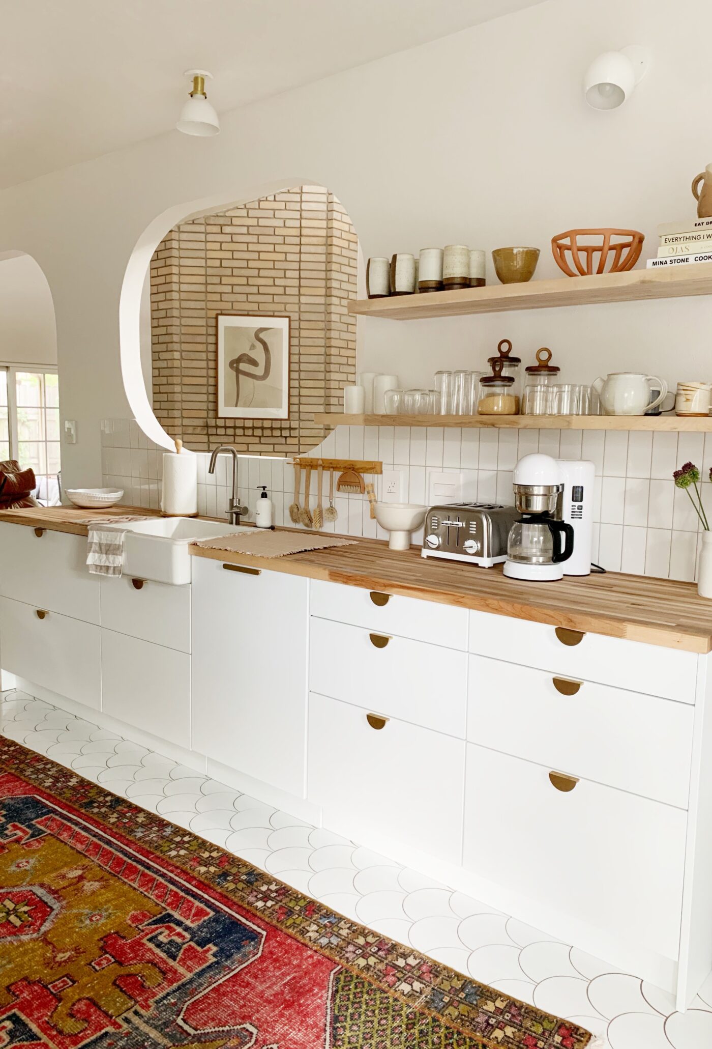 A Clever Cutout and White Kitchen Cabinets Make This Renovation Cozy