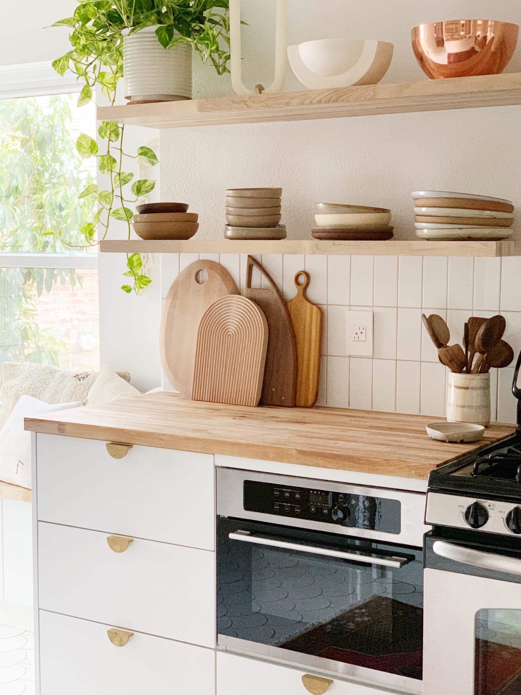 A Clever Cutout and White Kitchen Cabinets Make This Renovation Cozy